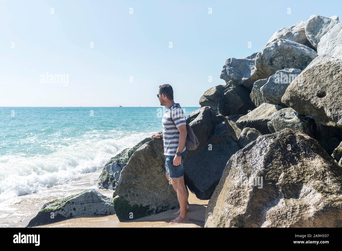 Man standing by the sea hi-res stock photography and images - Alamy