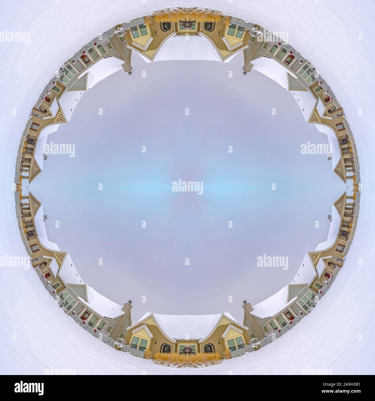 Circular design made from a winter village with fresh snow covering ...