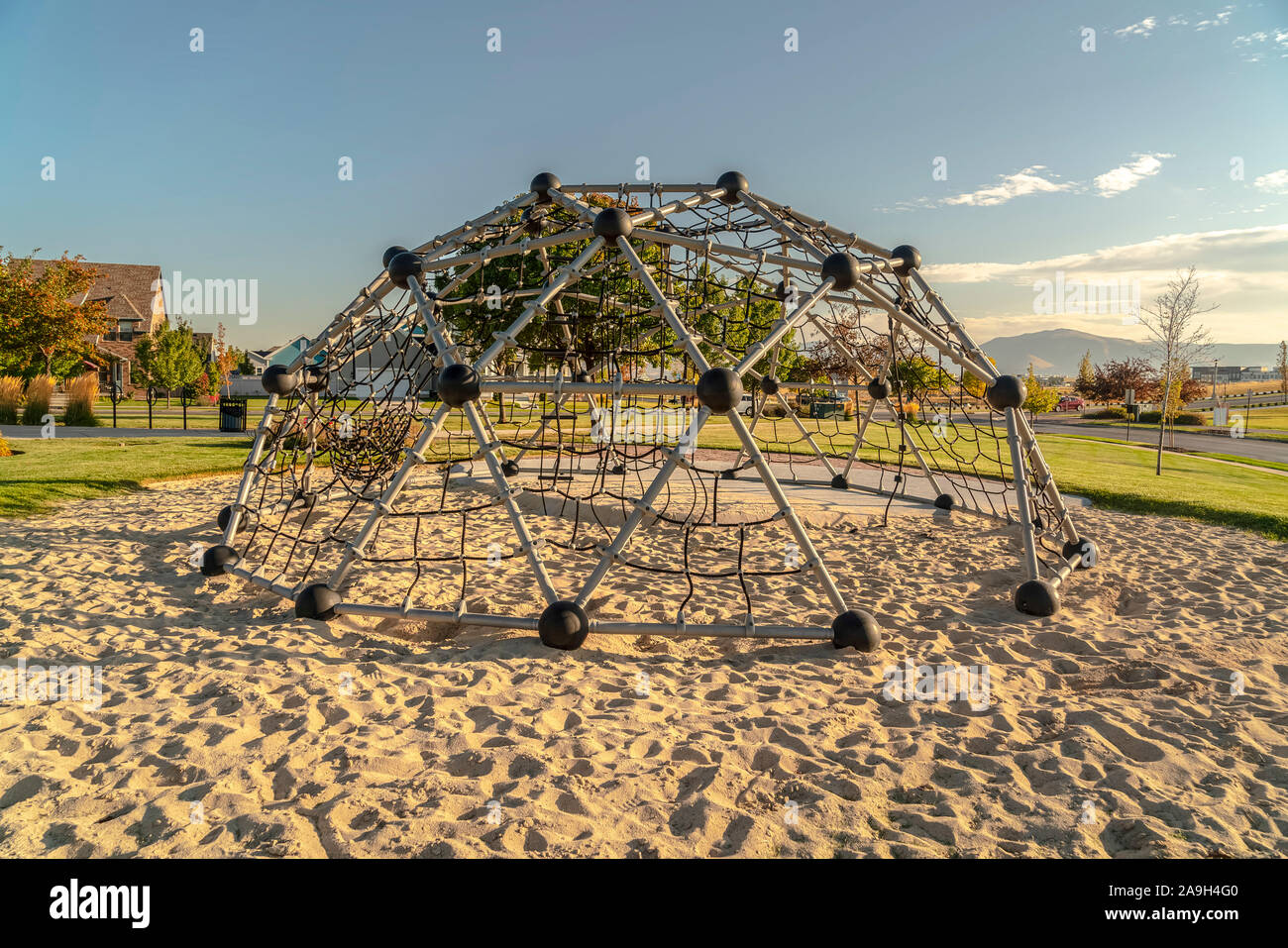 Metal climbing dome with nets in a playground Stock Photo - Alamy