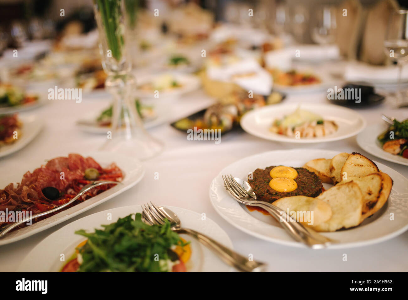 Table with mixed food. Banquet in restaurant, table setting. Differend ...