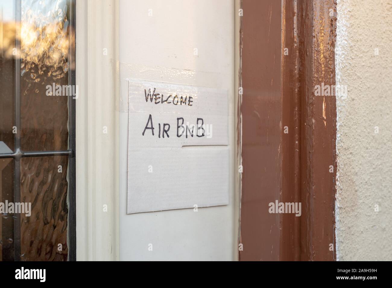 Close-up of hand drawn sign on door of a home reading Welcome AirBNB ...