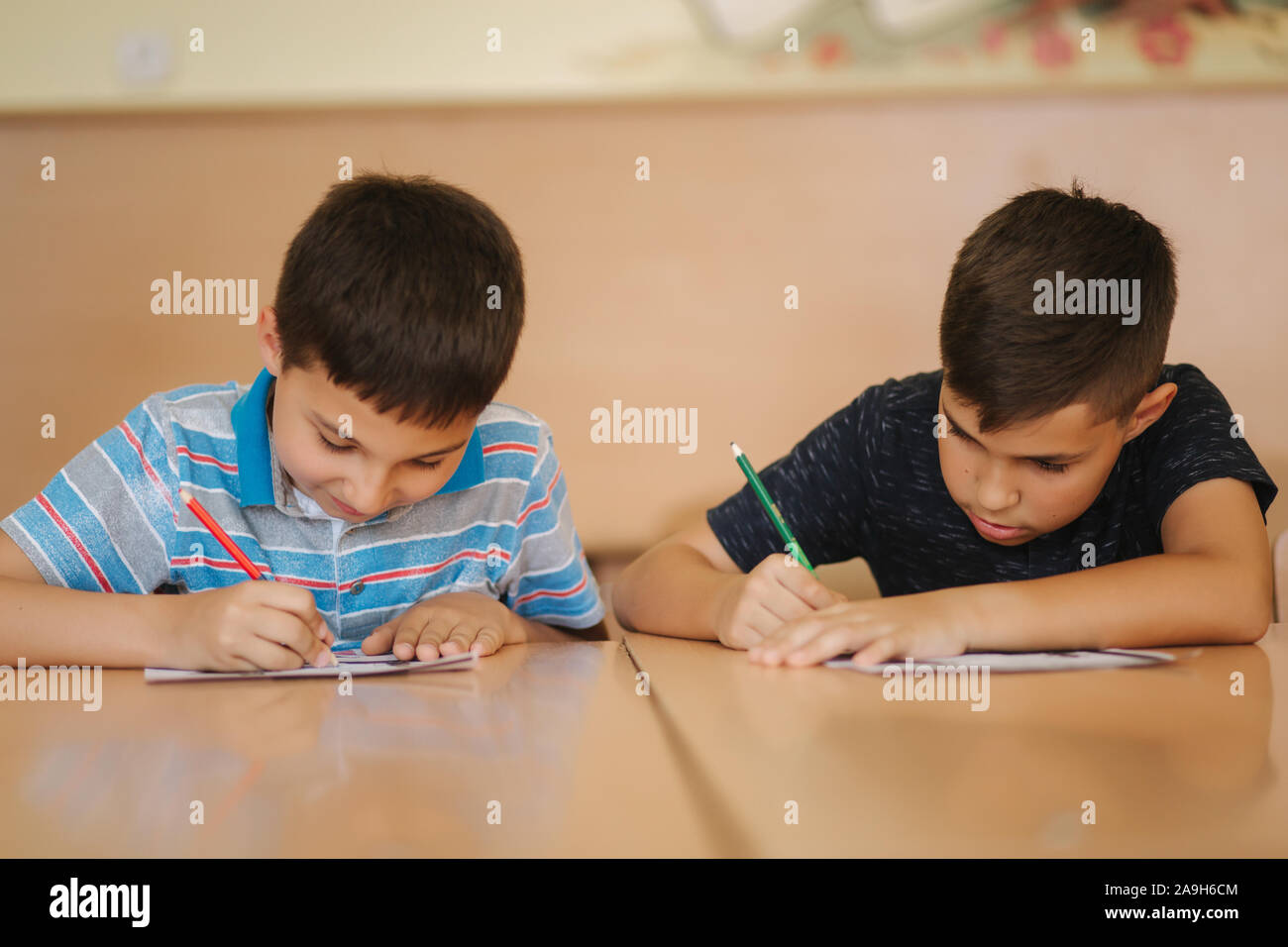 Two schoolboys writing text. Happy children Stock Photo - Alamy