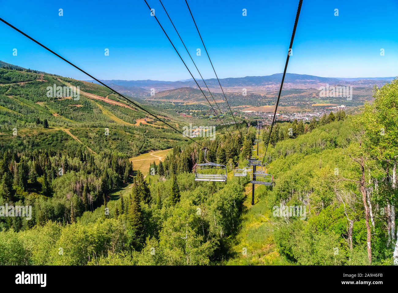Chairlifts and aerial view of mountain hiking trails and buildings in ...