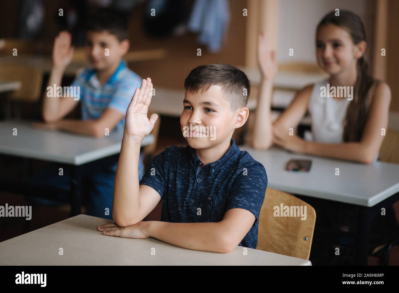 Happy little children in elementary scholl. Boys and girls study ...