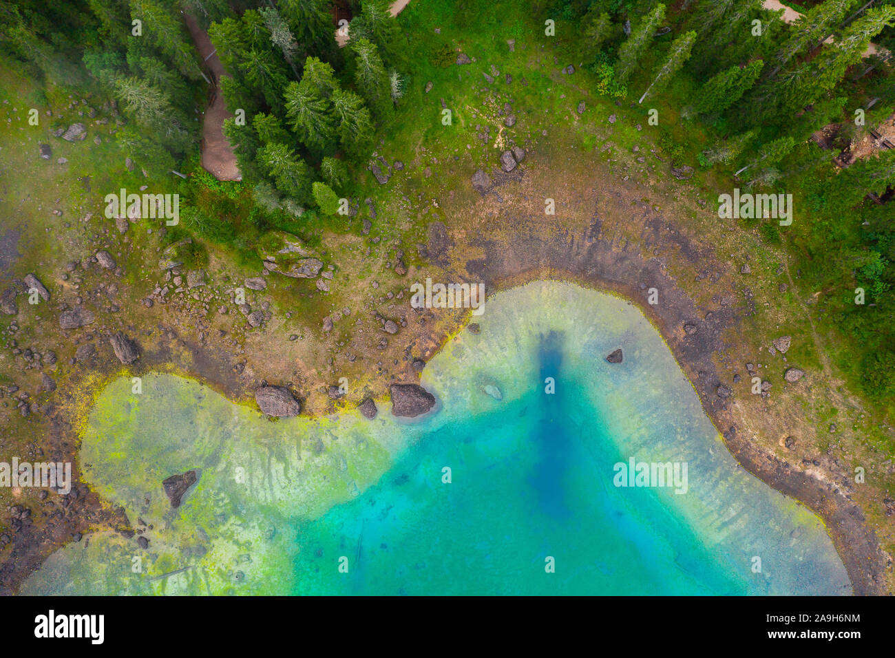 Aerial view of turquoise blue water of lake Carezza in Alps Dolomites ...