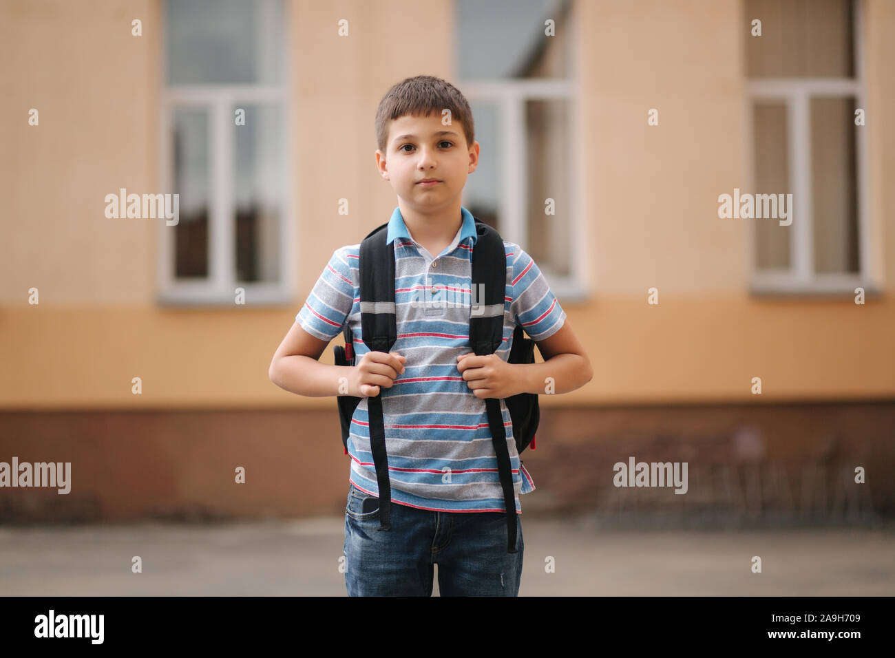 Cute little boy with backpack go home after scholl class Stock Photo ...