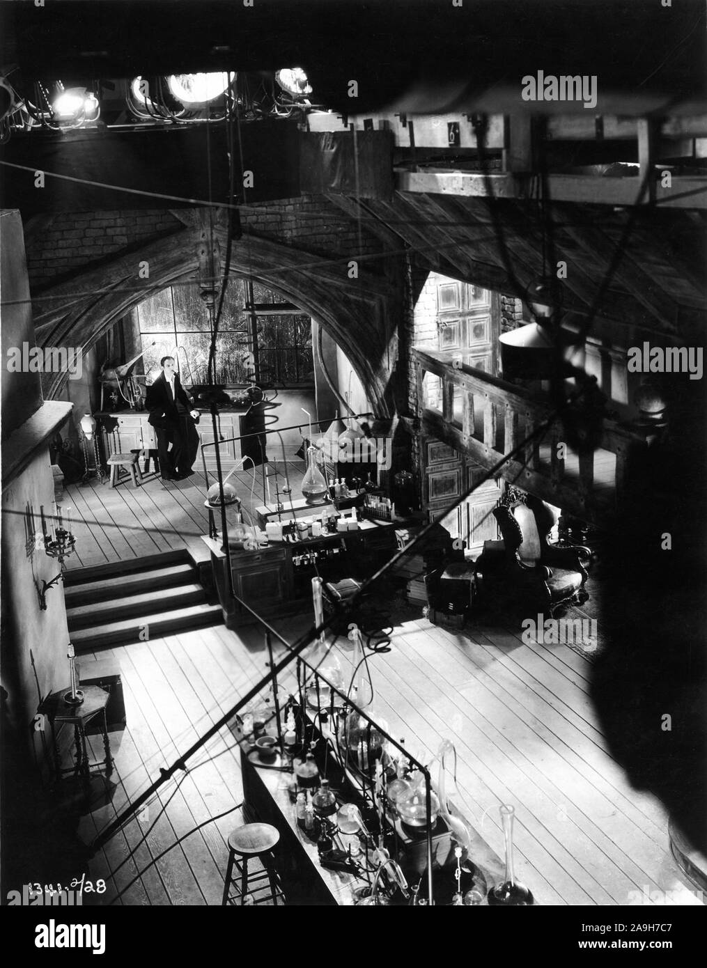 FREDRIC MARCH as Dr. Henry Jekyll on set candid filming on laboratory ...
