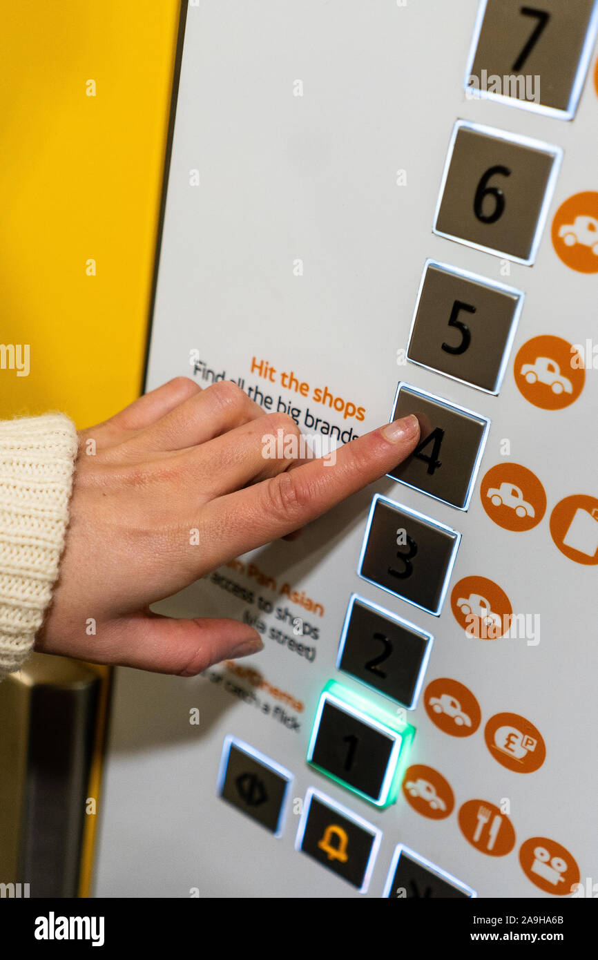 A women selects a flood by using her finger to press the button, lift ...