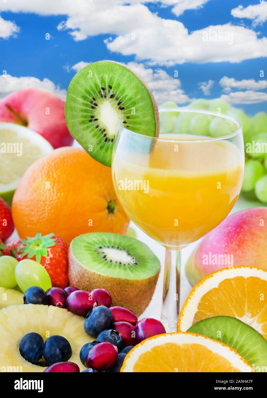 Glass of vitamin juice and fresh fruits Stock Photo - Alamy