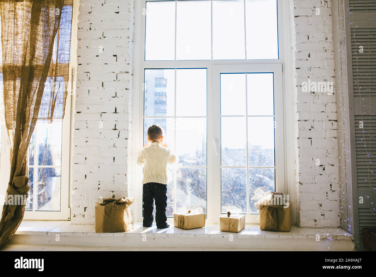 Christmas concept. Theme Christmas morning. Dreaming boy in ...