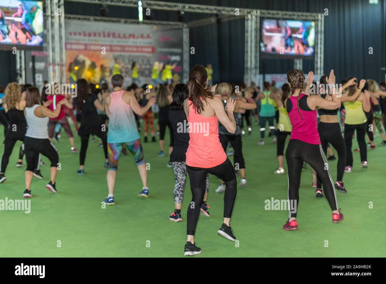 Fitness Workout in Gym: People doing Exercises in Class with Music and ...