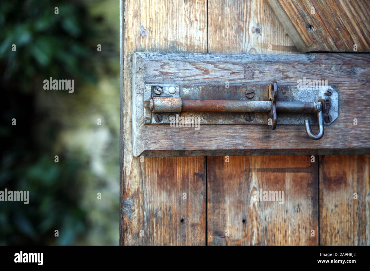 Artistic close up shot of an old iron or steel bolt, on a rustic wooden ...