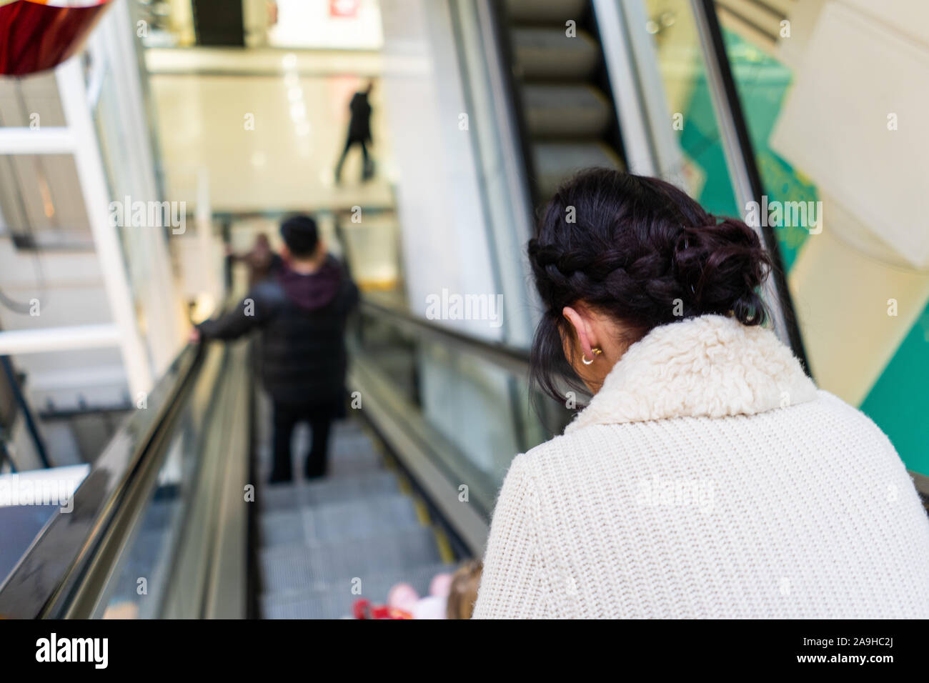 People using escalators at Christmas time in the Primark store, shop ...