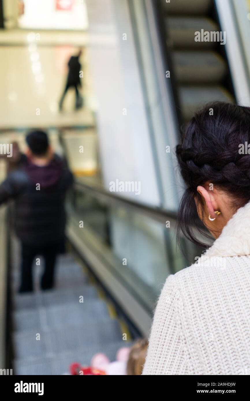 People using escalators at Christmas time in the Primark store, shop ...