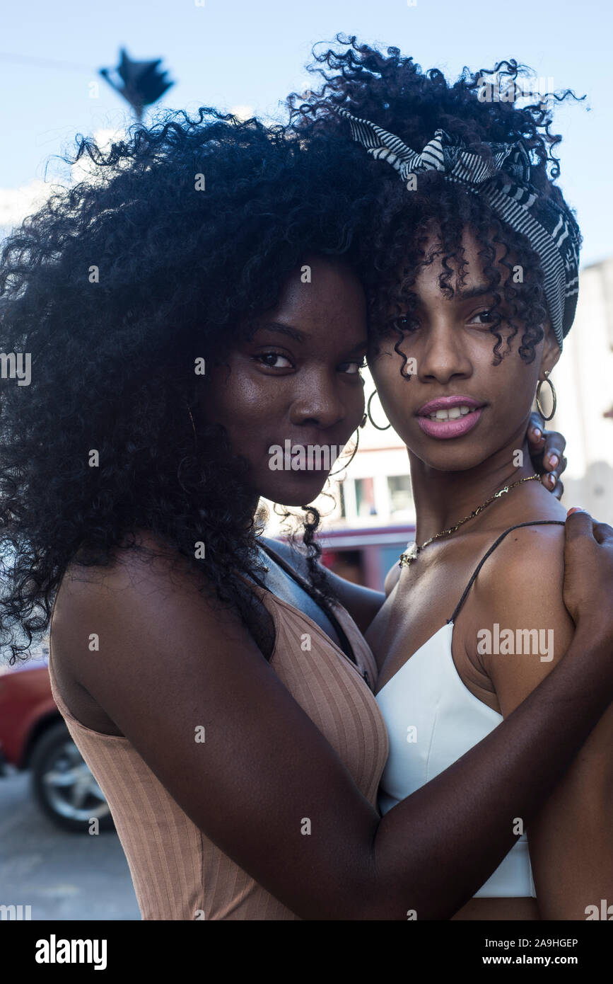 Two young Cuban women hugging Stock Photo - Alamy