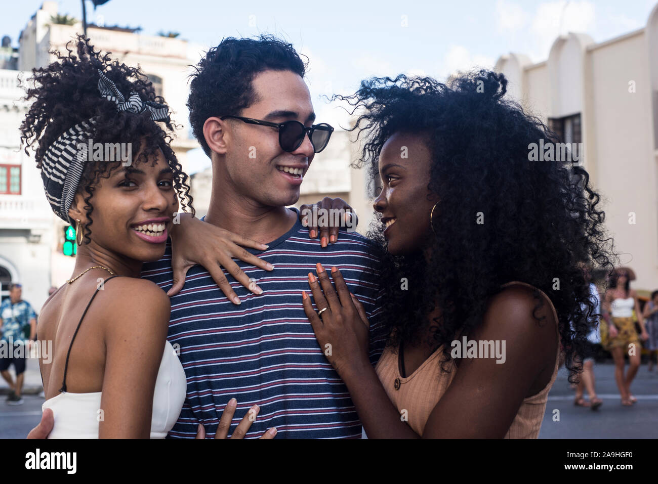 Three young people having fun Stock Photo - Alamy