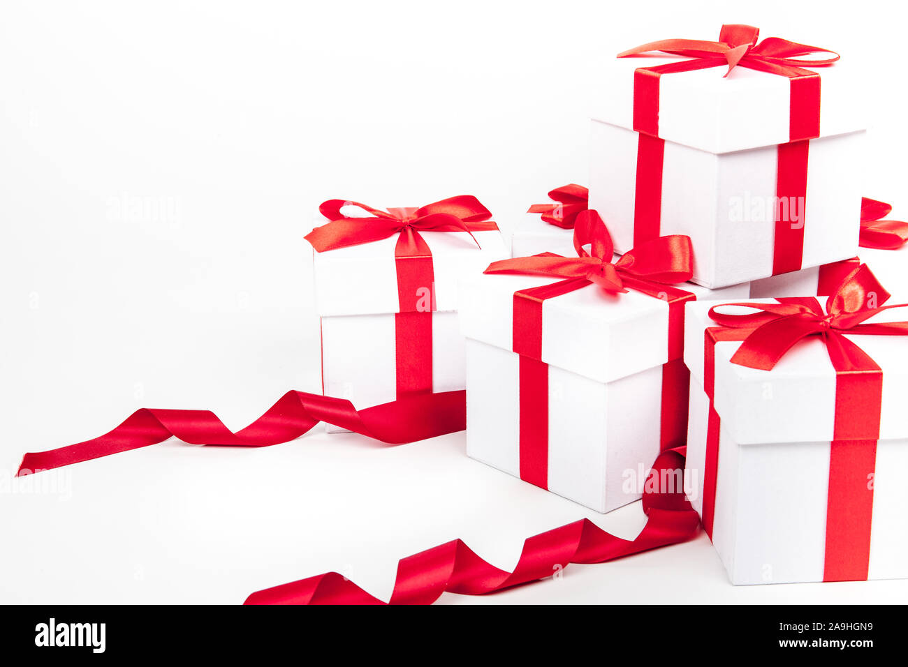 White boxes with a red satin ribbon bow Isolated on white background ...