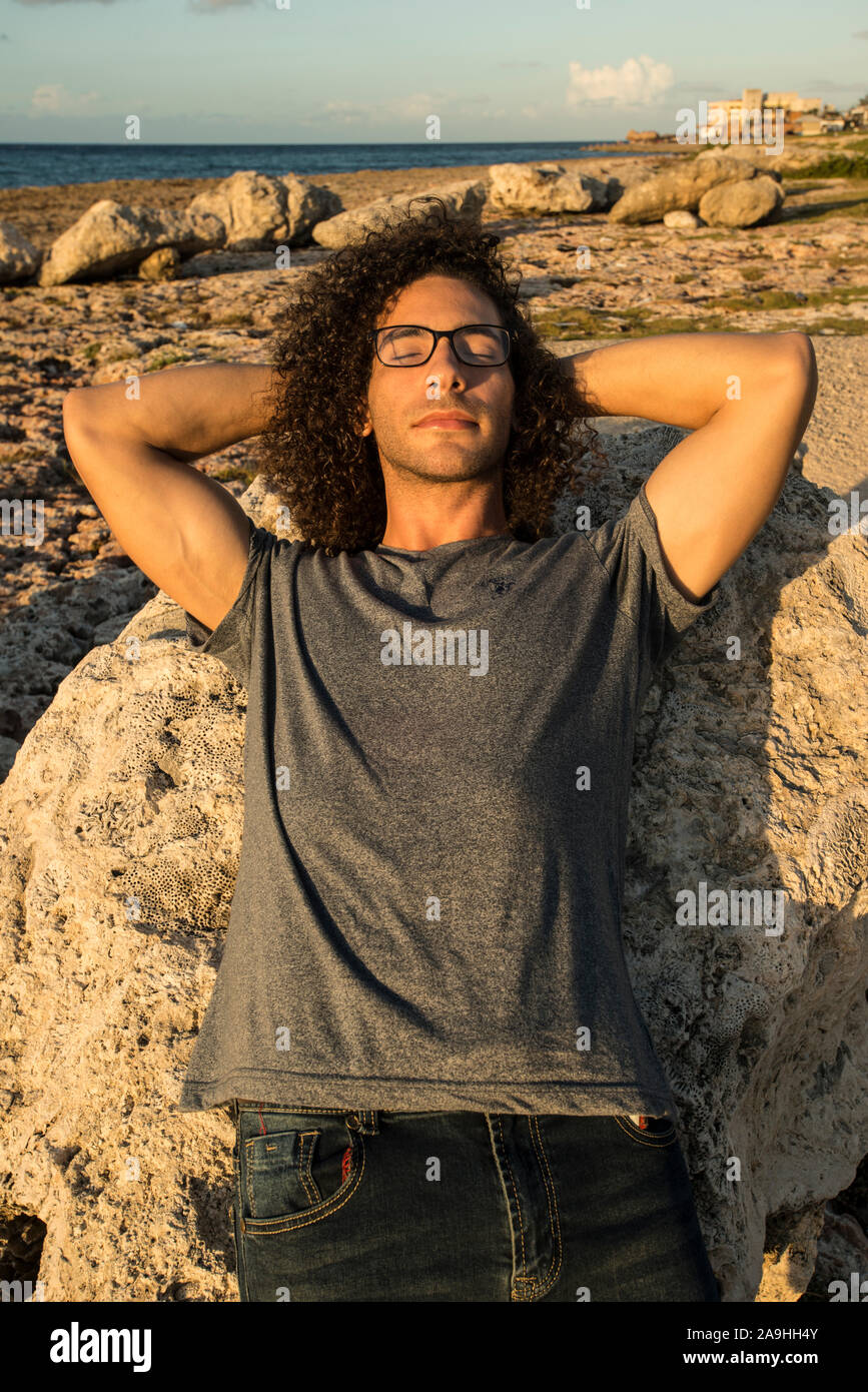 Young Latin man relaxed on the beach Stock Photo - Alamy