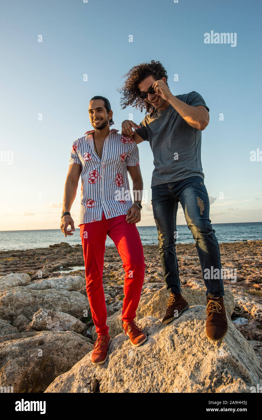 Two Cuban friends having fun on the beach Stock Photo - Alamy