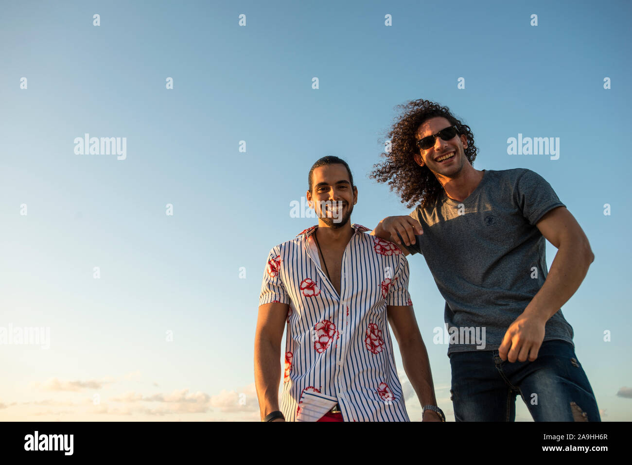 Two Cuban friends having fun on the beach Stock Photo - Alamy