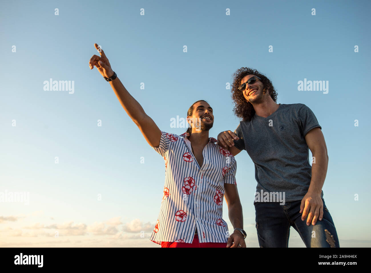 Two Cuban friends having fun on the beach Stock Photo - Alamy