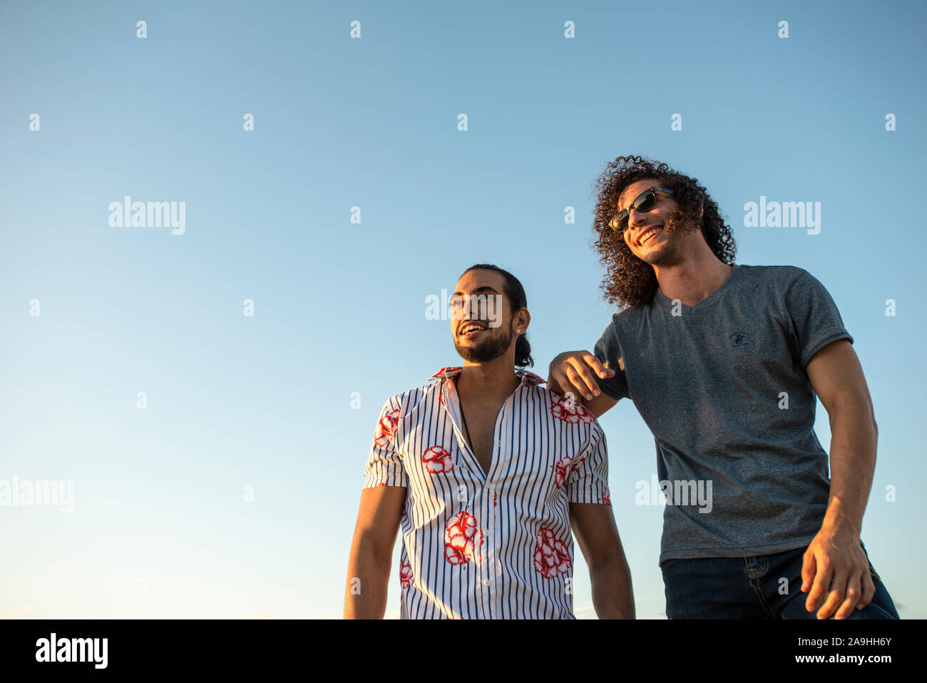 Two Cuban friends having fun on the beach Stock Photo - Alamy