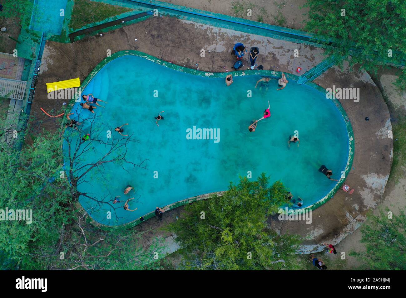 Aerial view of vacationers bathing in the hot spring pool of the ...