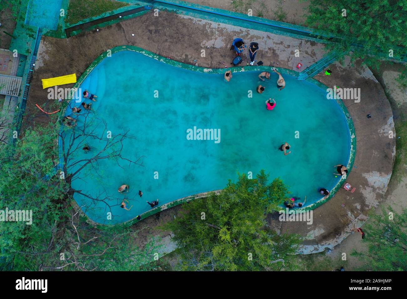 Aerial view of vacationers bathing in the hot spring pool of the ...