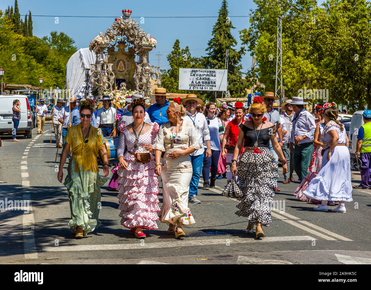 The Romería de El Rocío or El Rocío pilgrimage passing though the town ...