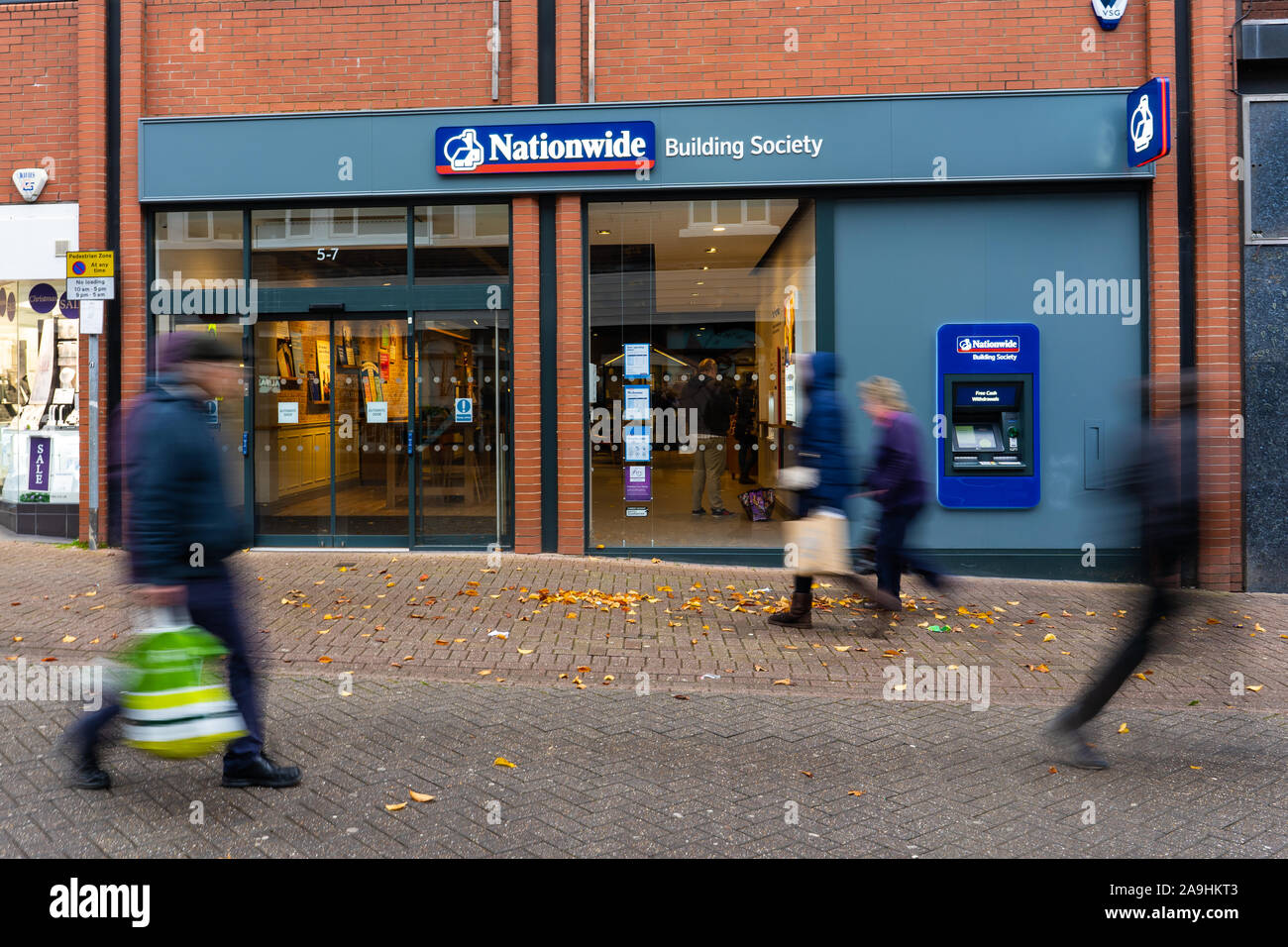 People, shoppers walk past the Nationwide building society and bank on ...