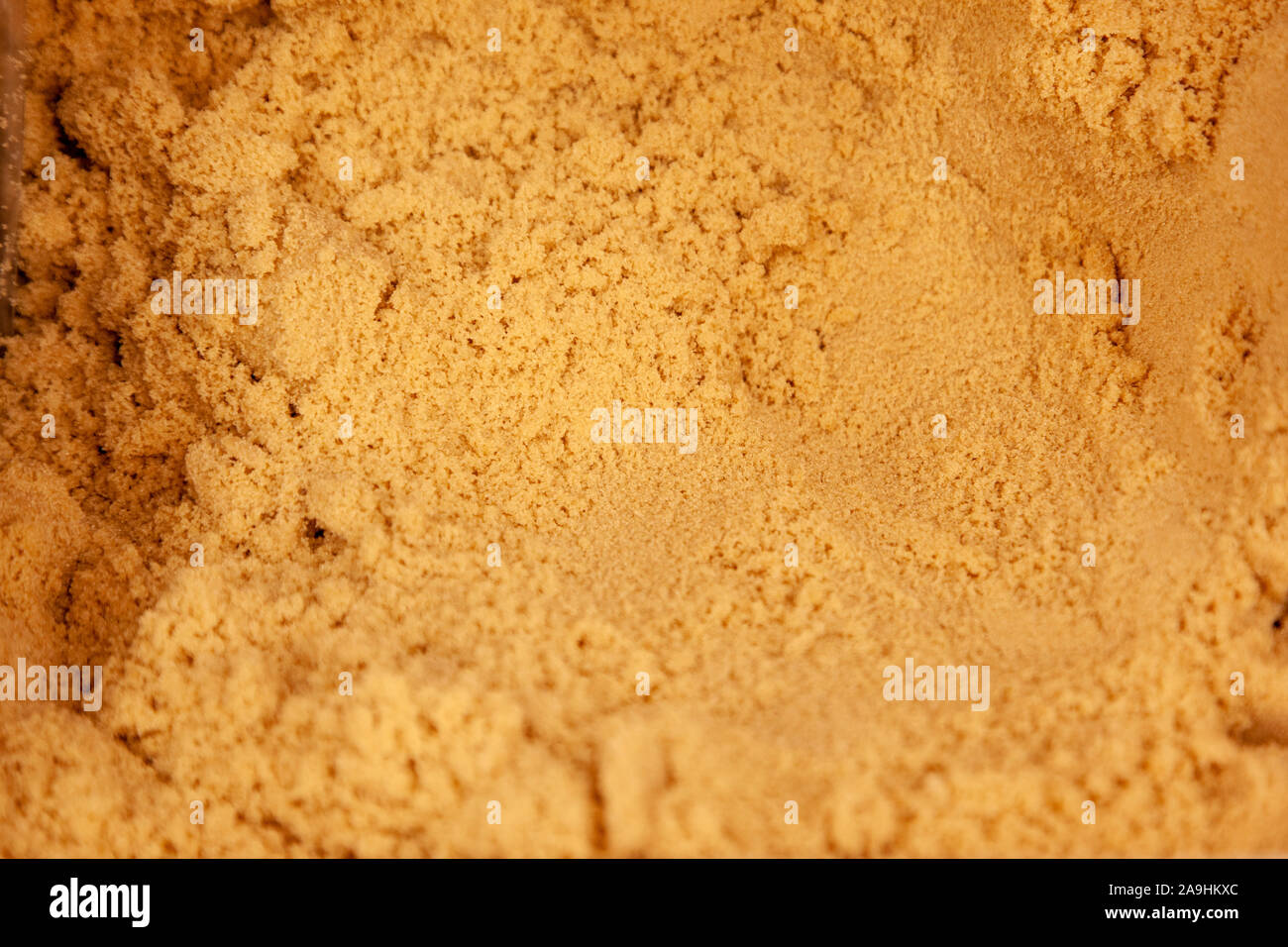 baking ingredient of yellow sugar in a bin ready to be used in a recipe ...