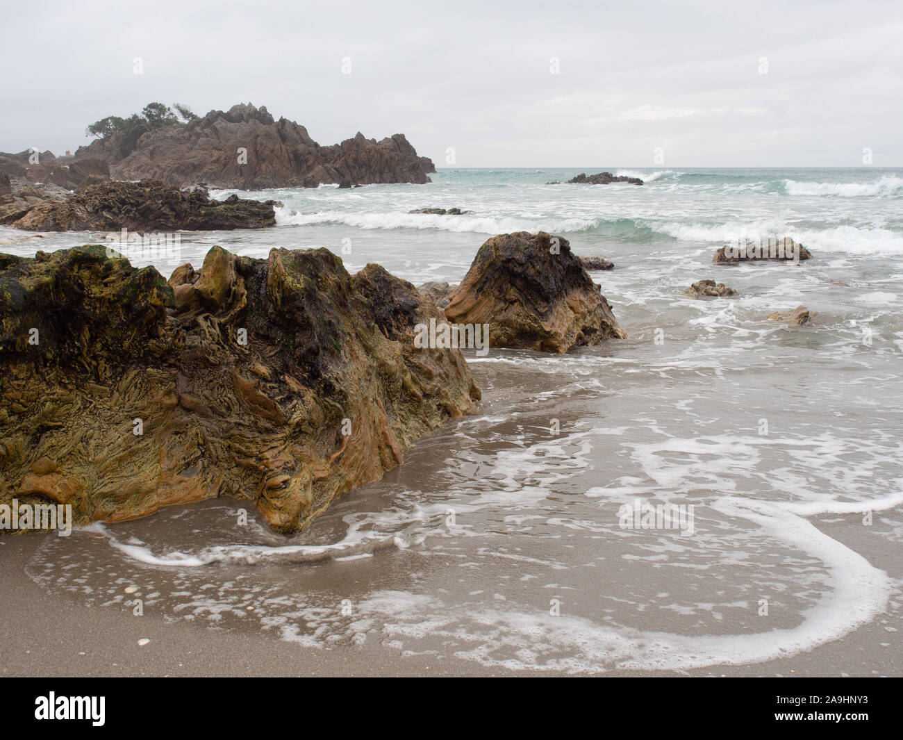 Waves Around Rocks At The Beach Stock Photo - Alamy