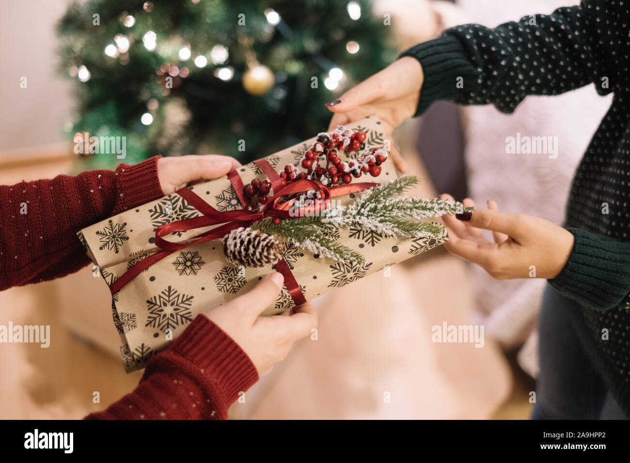 Woman giving decorated present to a child Stock Photo - Alamy