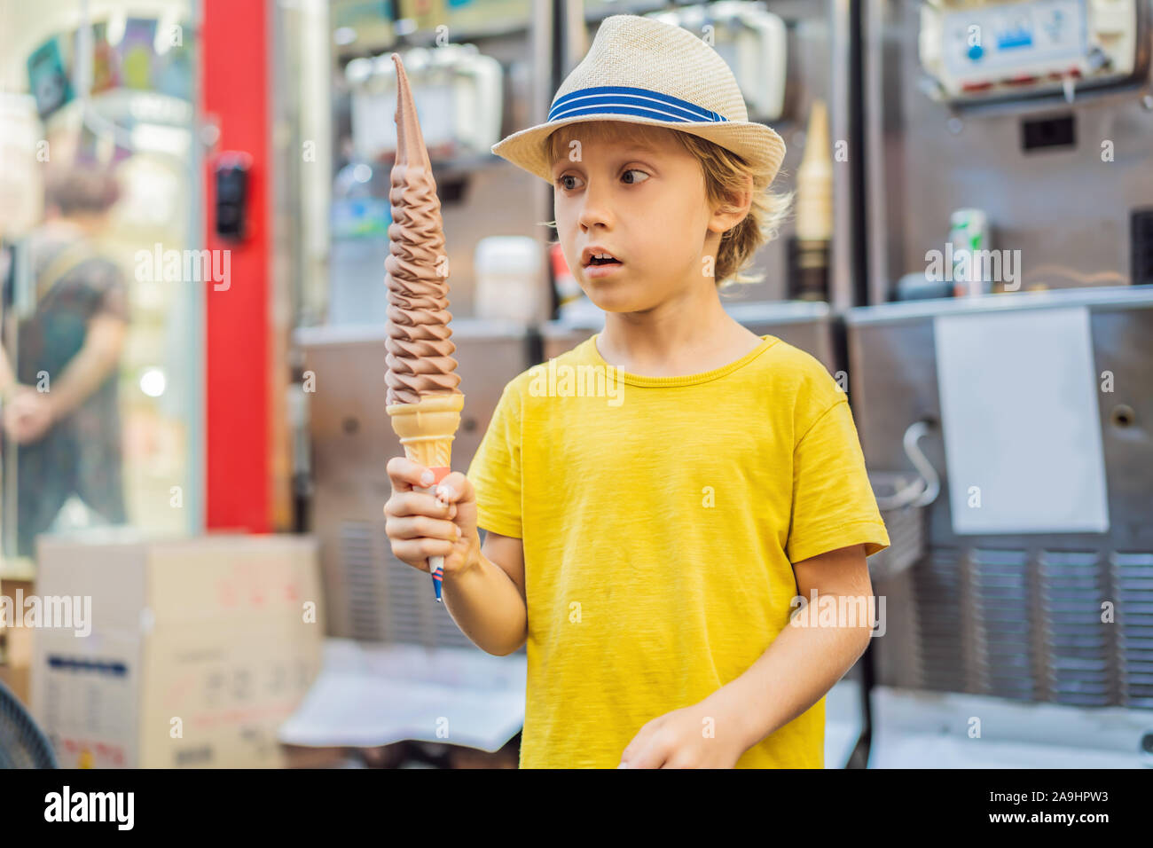 Little tourist boy eating 32 cm ice cream. 1 foot long ice cream. Long ...