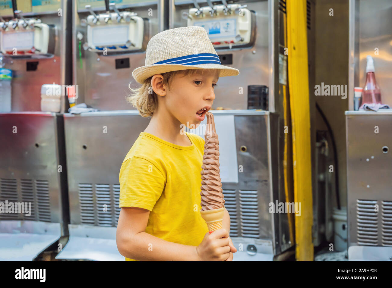 Little tourist boy eating 32 cm ice cream. 1 foot long ice cream. Long ...