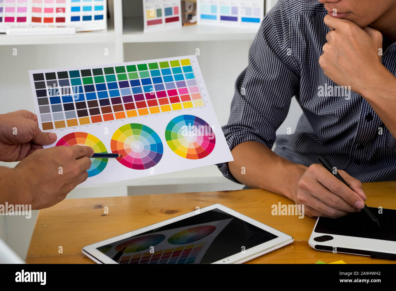 Graphic designers present colors from the color palette to their ...