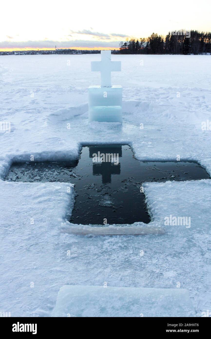 Ice cross hole and a cross of ice for the holidays of Orthodox baptism ...