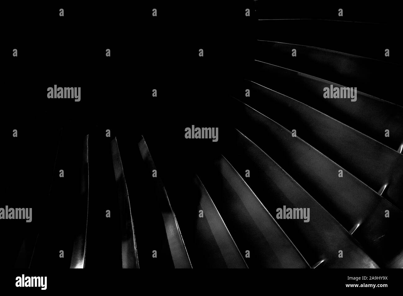 Black and white, close up front view of aircraft jet engine intake fan ...