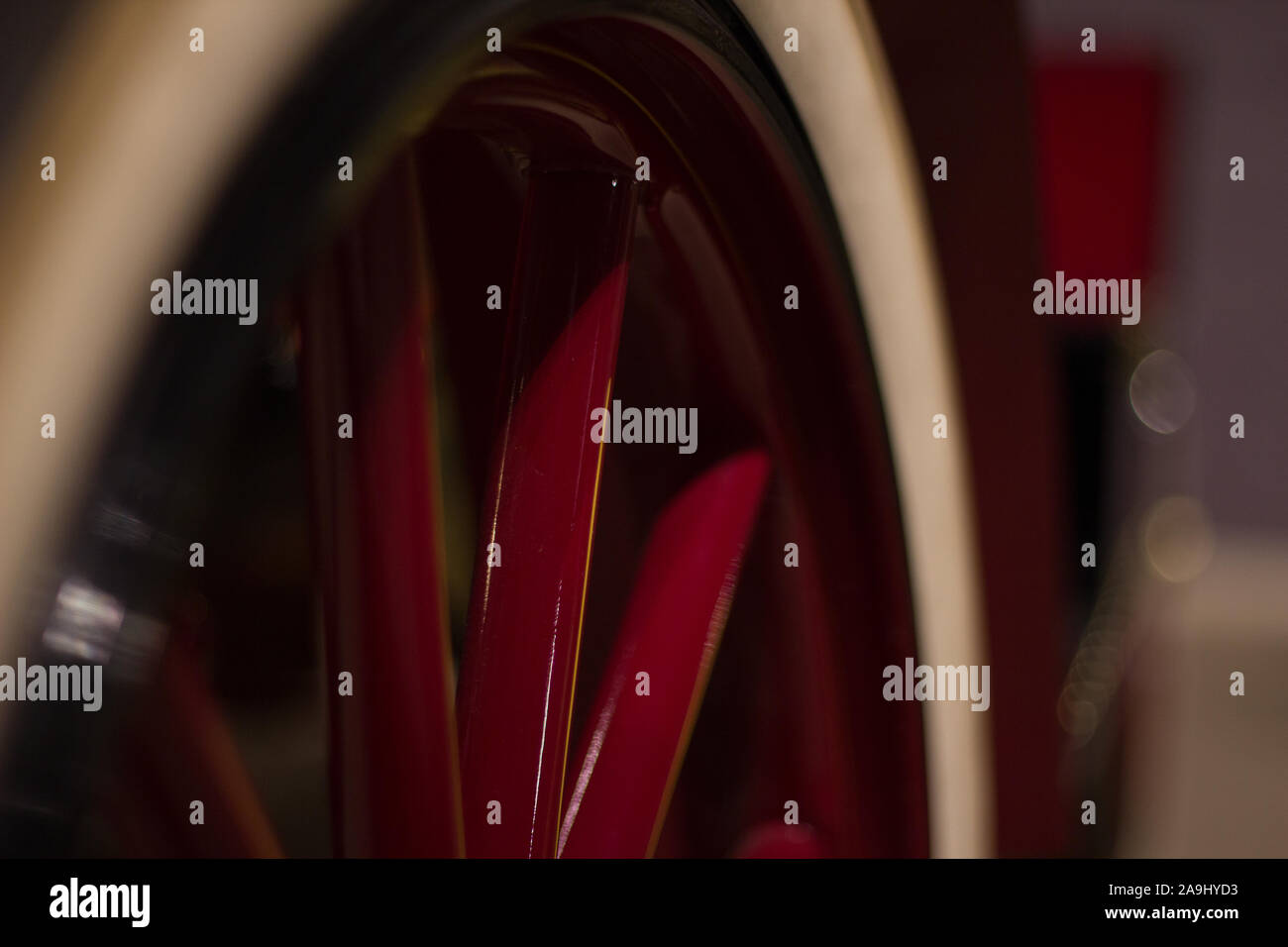 Front view, red spokes on a white wall tire, antique red automobile ...