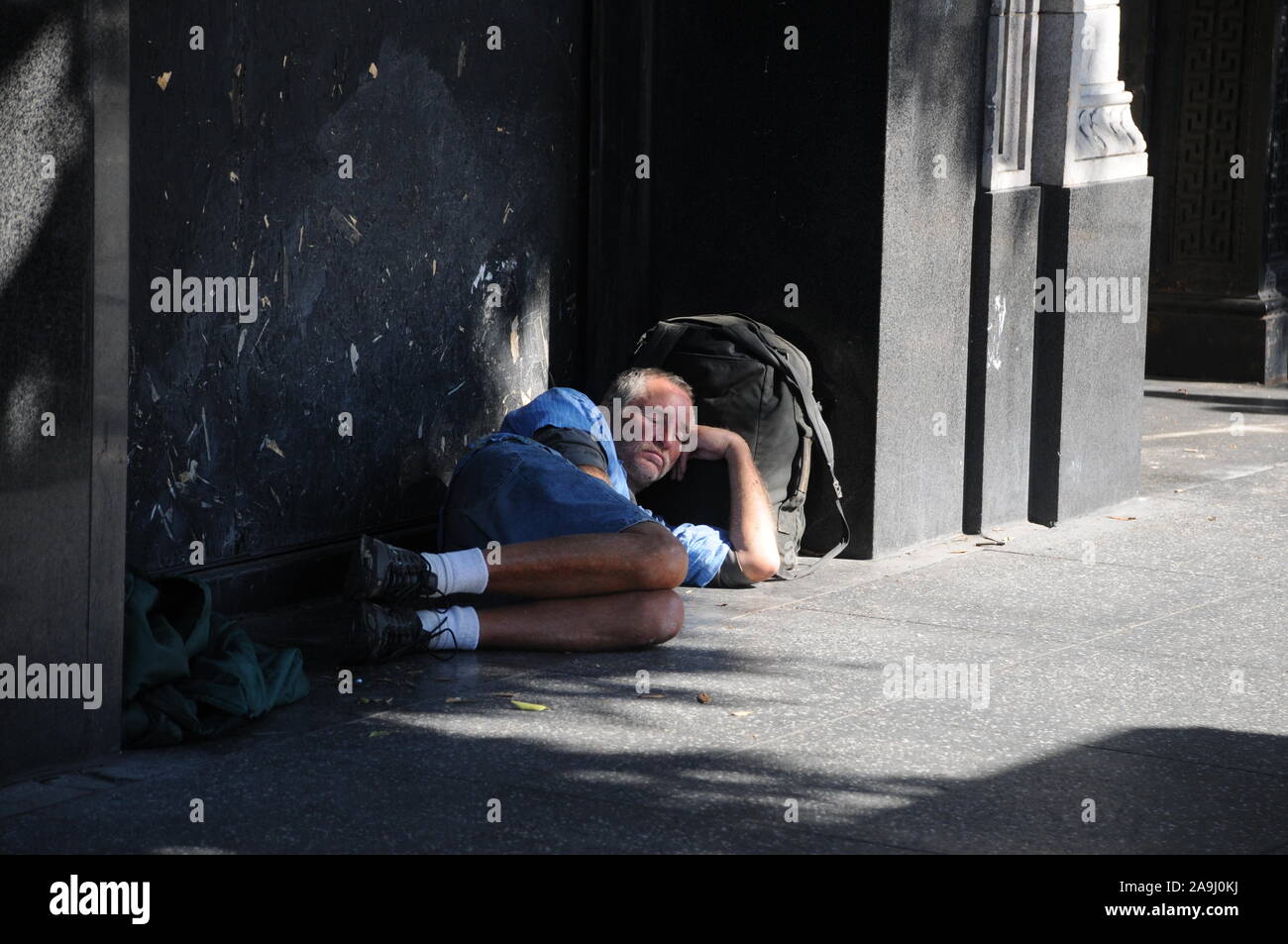 Homeless man laying sidewalk hi-res stock photography and images - Alamy