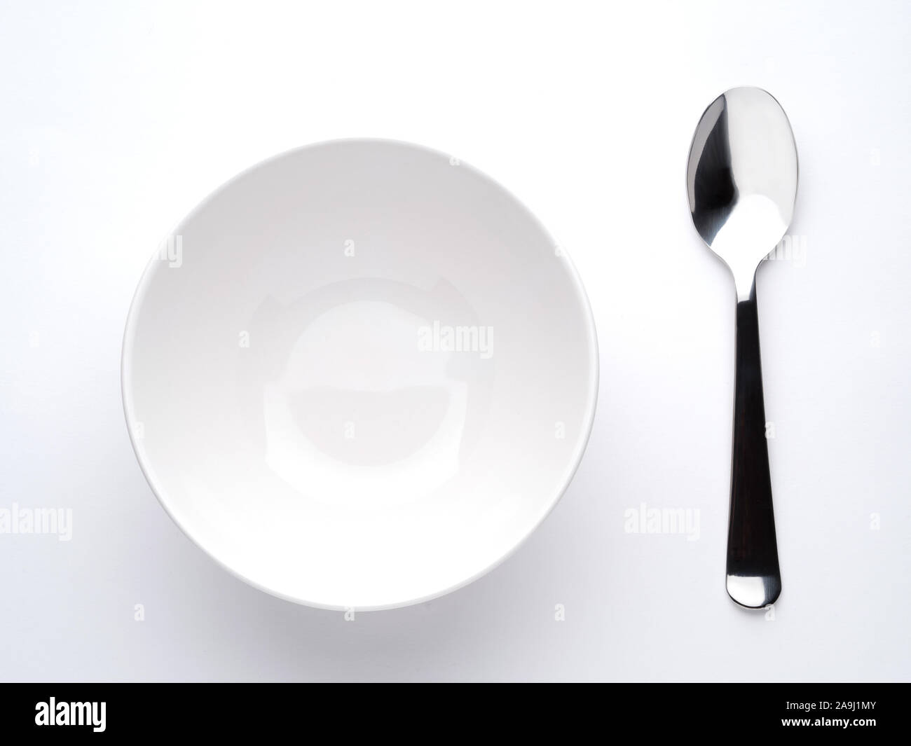 deep soup plate and spoon on white background, top view Stock Photo - Alamy