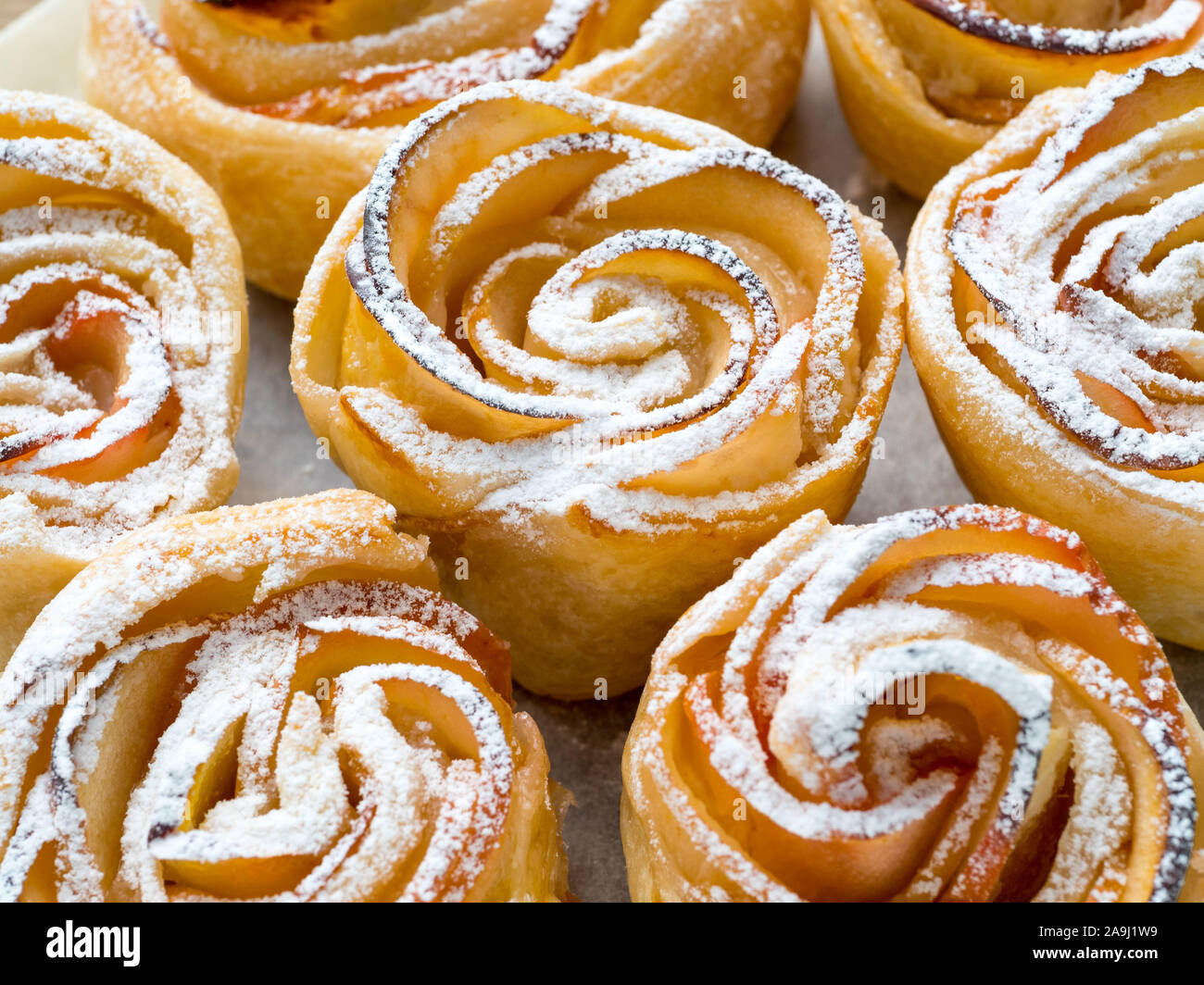 homemade pastries of flaky unleavened dough with apples on parchment ...
