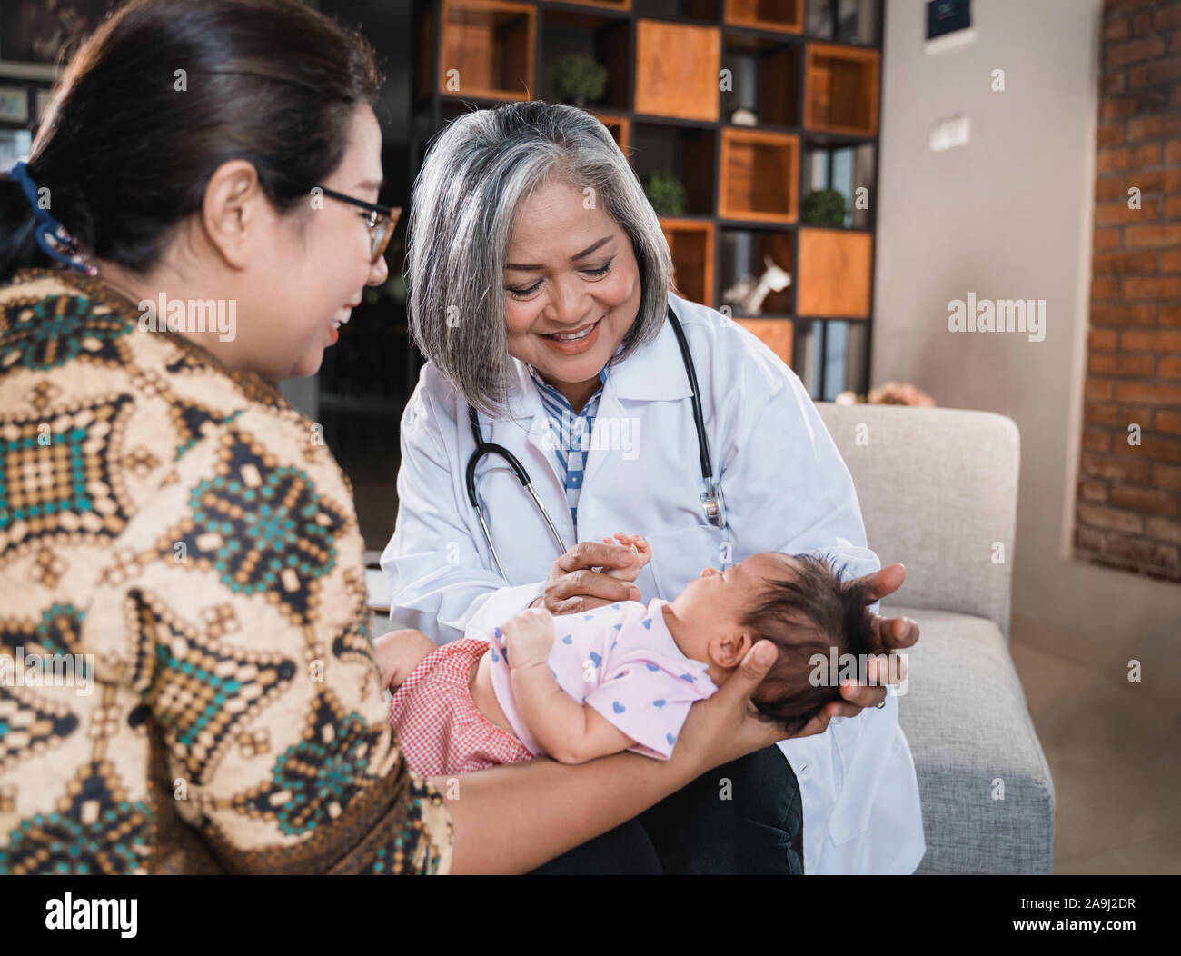 doctor examines a small baby Stock Photo - Alamy