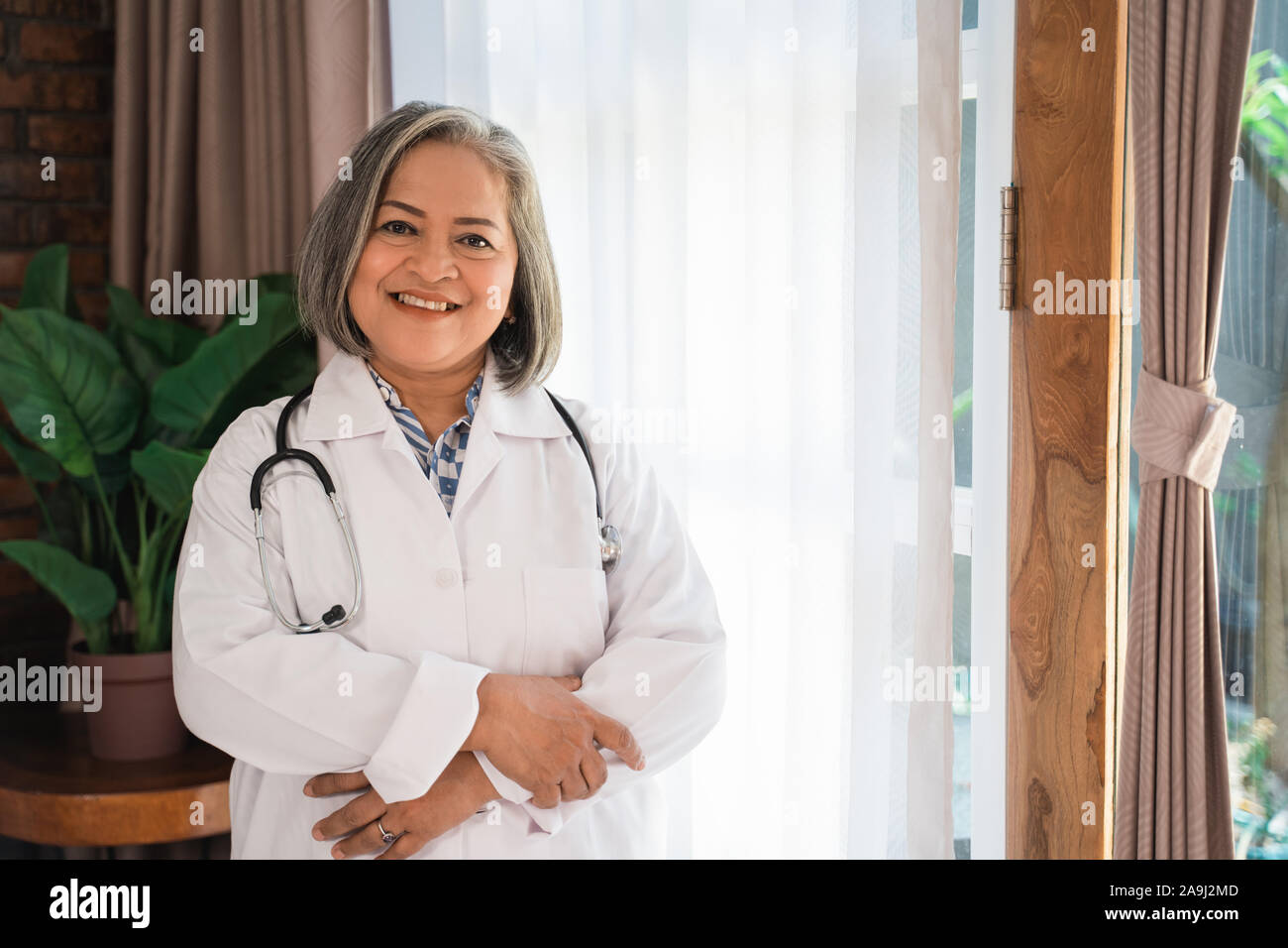 Confident female doctor with smiling Stock Photo - Alamy