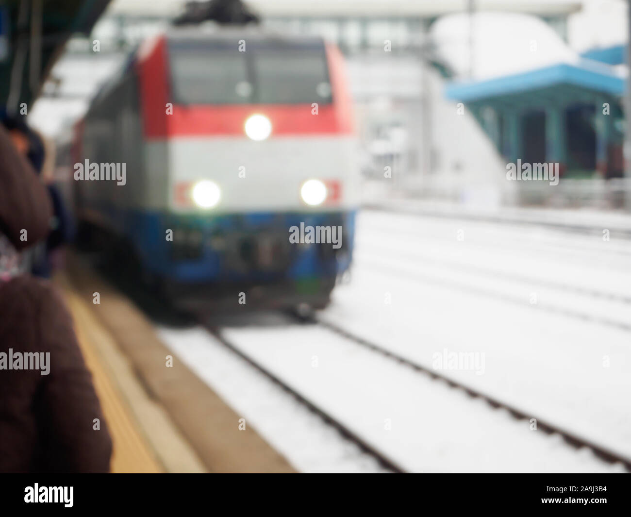 Defocused background of trainstaion platform and moving train in South ...