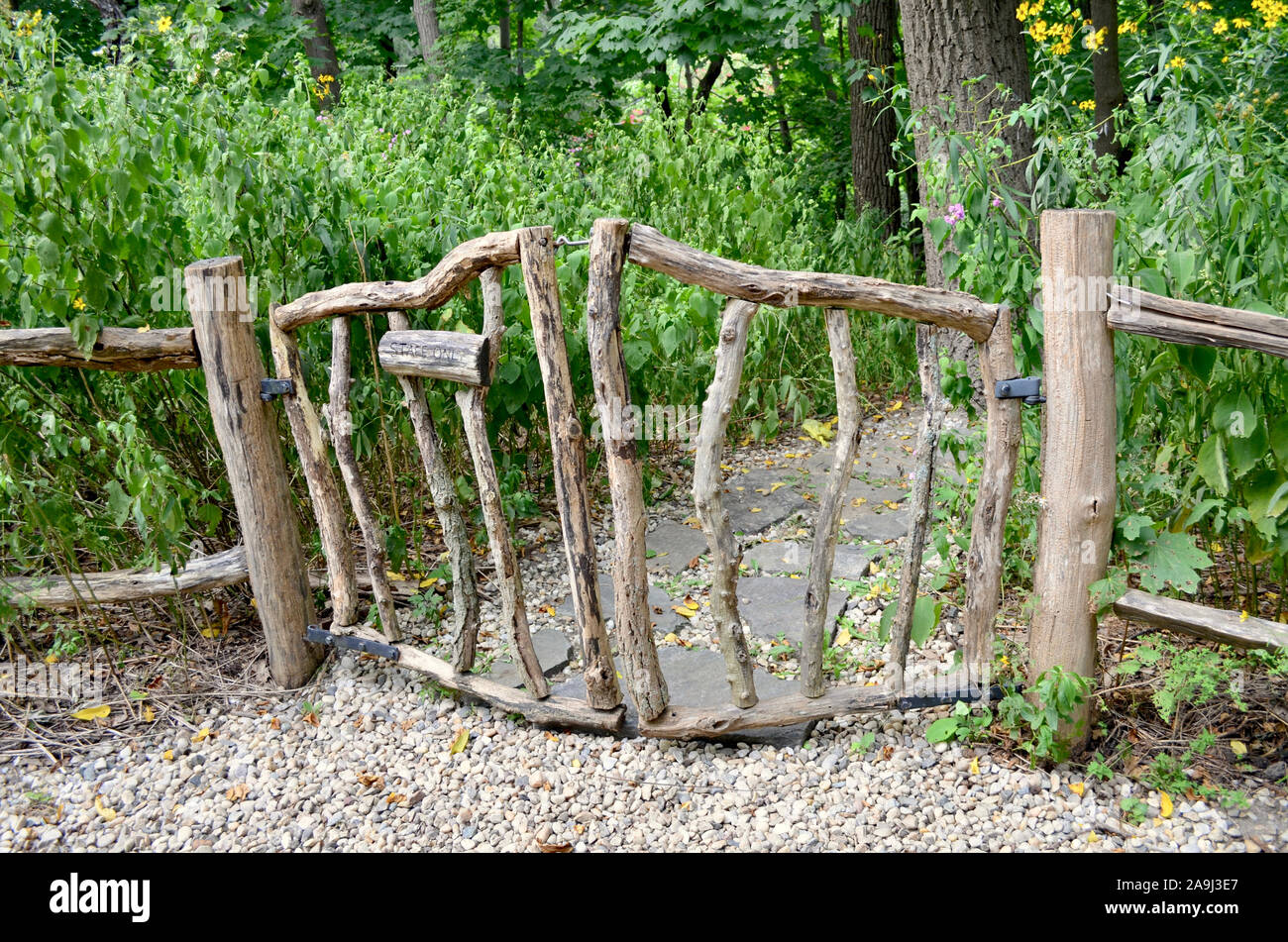 Unique rustic wood gate made to look like a part of nature. Closeup ...