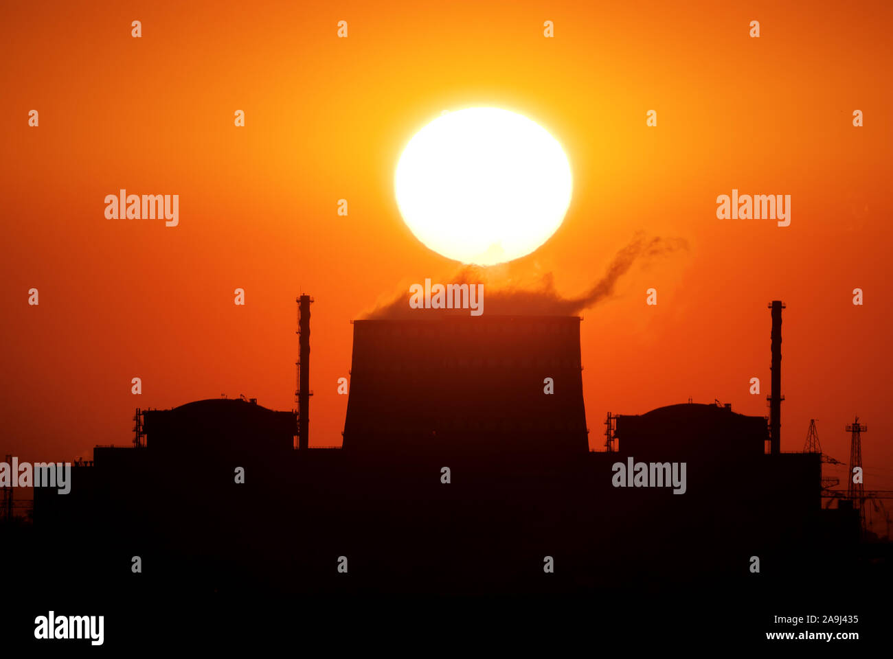Power plant on the sunset. Big sun and energy industry Stock Photo - Alamy