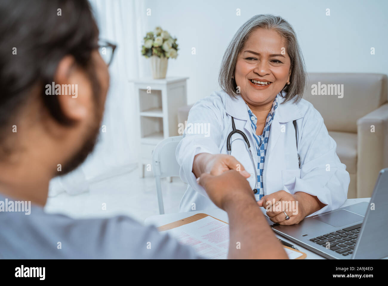 doctor shakes hands with the patient Stock Photo - Alamy