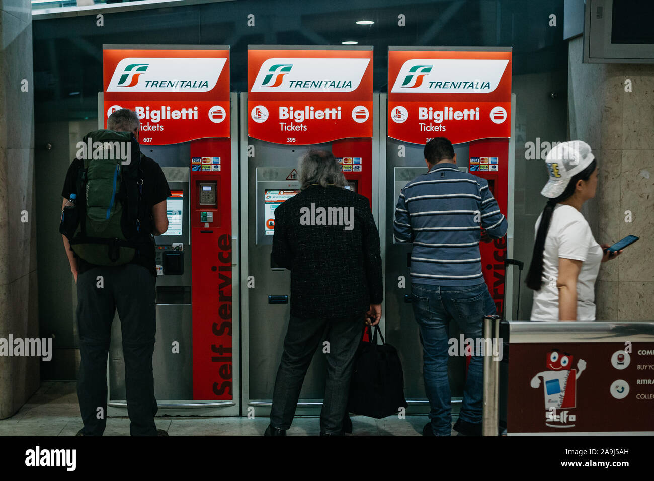 Italy, Milan, July 12, 2019: People buy tickets at self-service ...