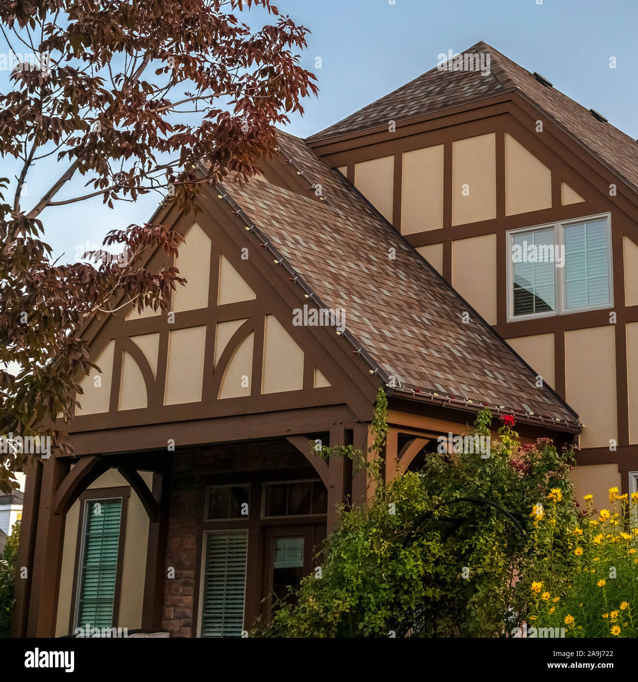 Square Unusual timber frame house with double apex roof Stock Photo - Alamy